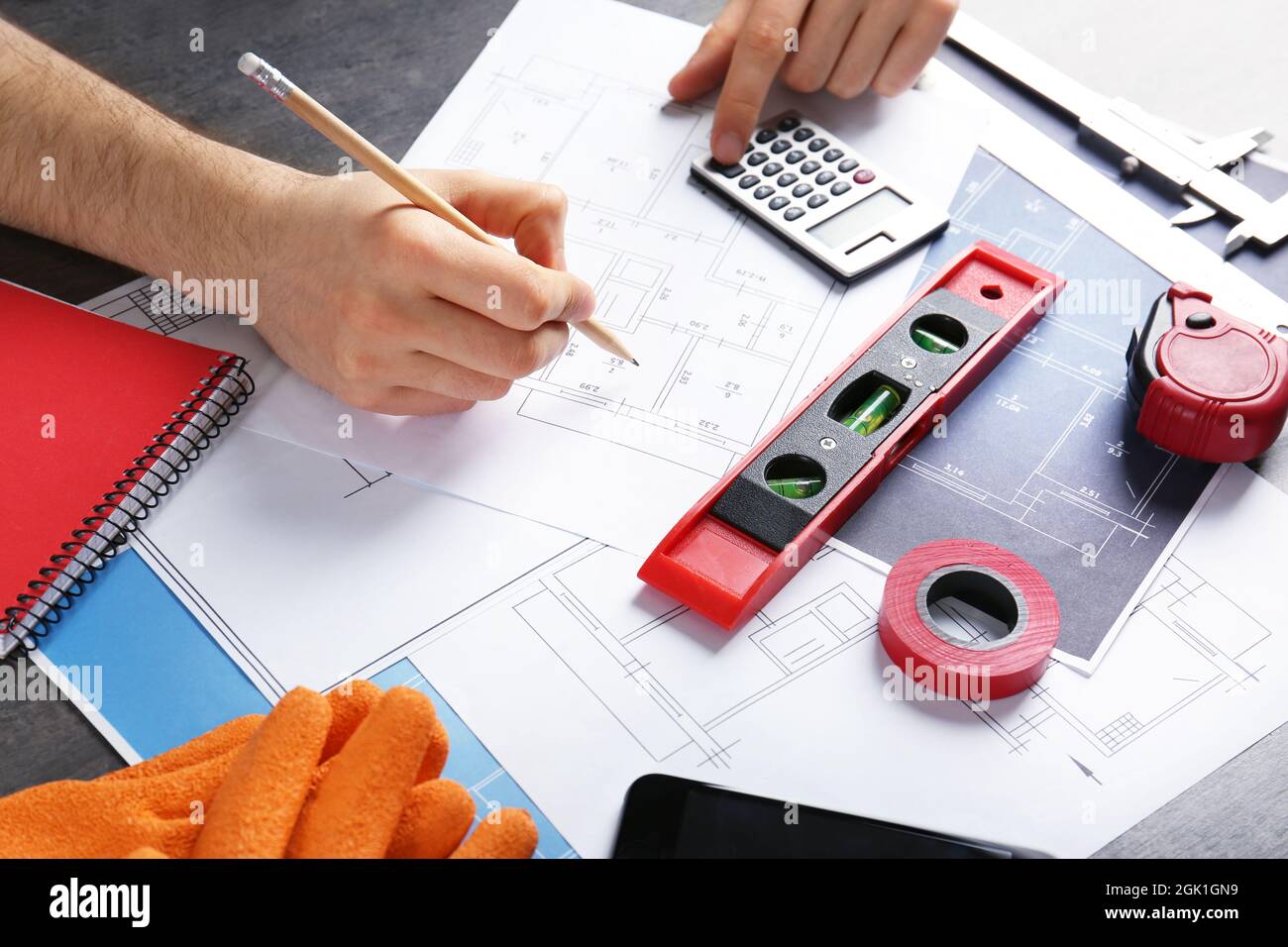 Engineer working at table with drawings Stock Photo - Alamy