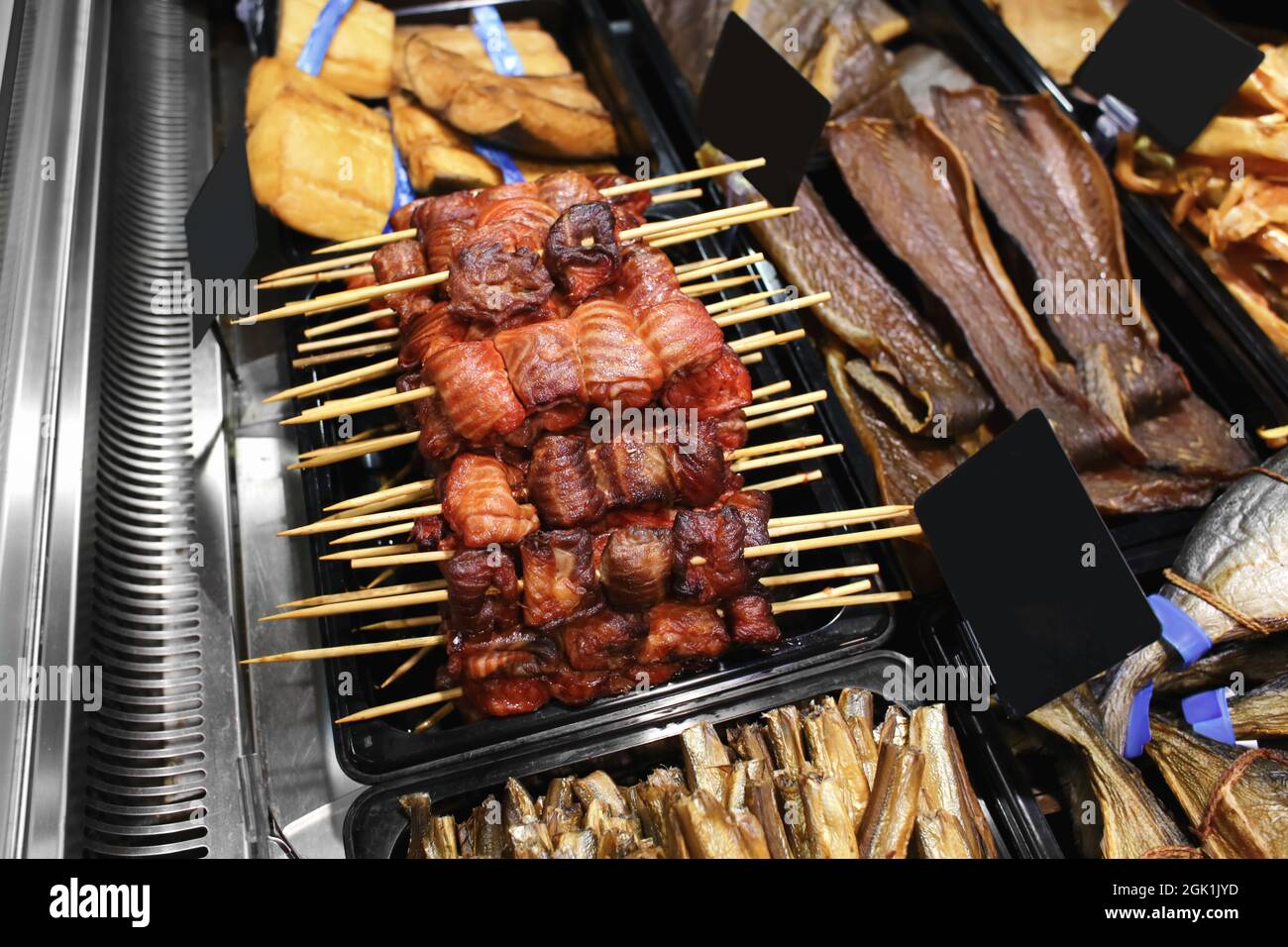 Tray with smoked fish in supermarket Stock Photo - Alamy