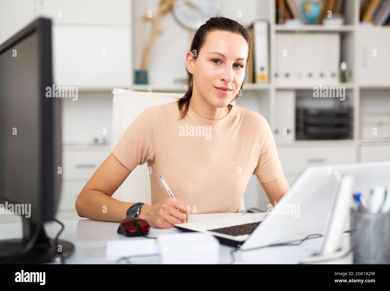 Girl business manager in the office makes important notes Stock Photo ...
