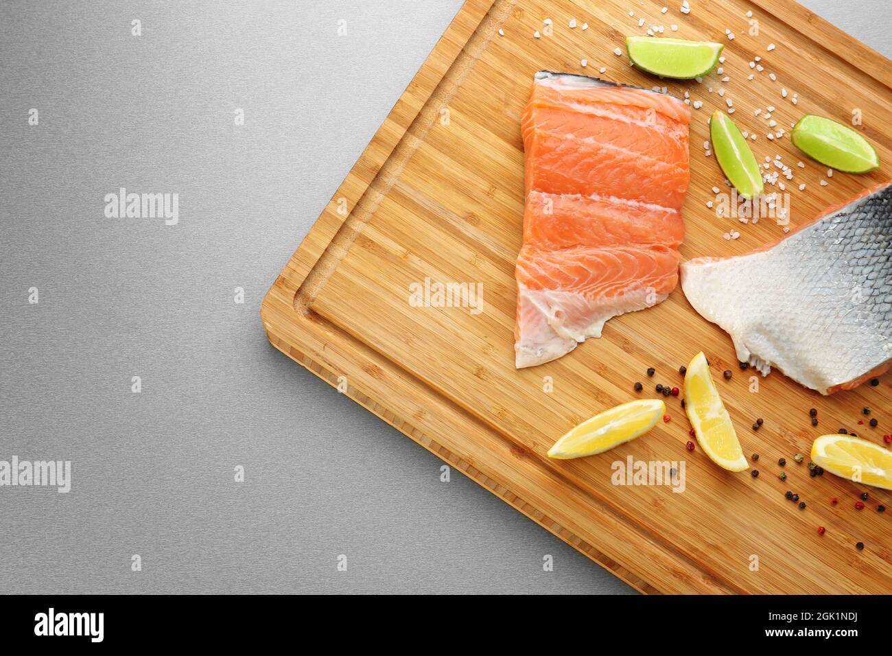 Fresh salmon fillet with spices and citrus fruits on wooden board Stock ...