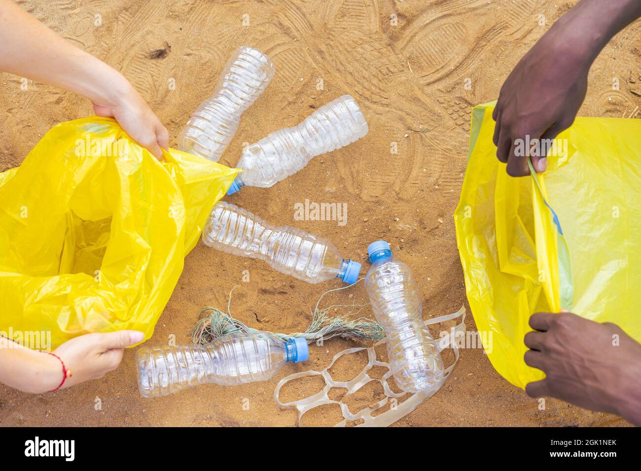Hands picked plastic bottle waste on beach,garbage is on beach ...