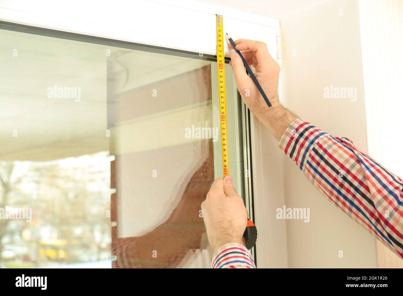 Male hands marking off window frame Stock Photo - Alamy
