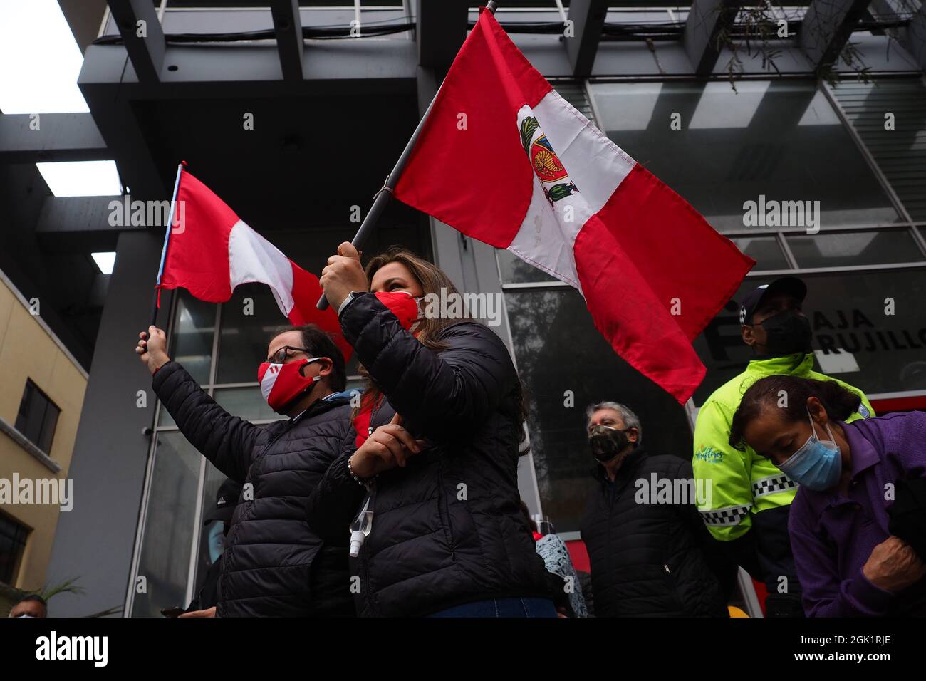 Couple with Peruvian flags when hundreds of people gather to celebrate ...