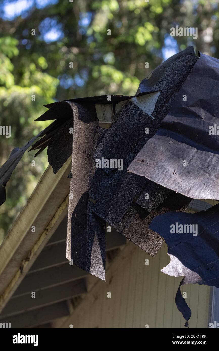 Loose shingles scrapped off roof dangling on the edge Stock Photo - Alamy