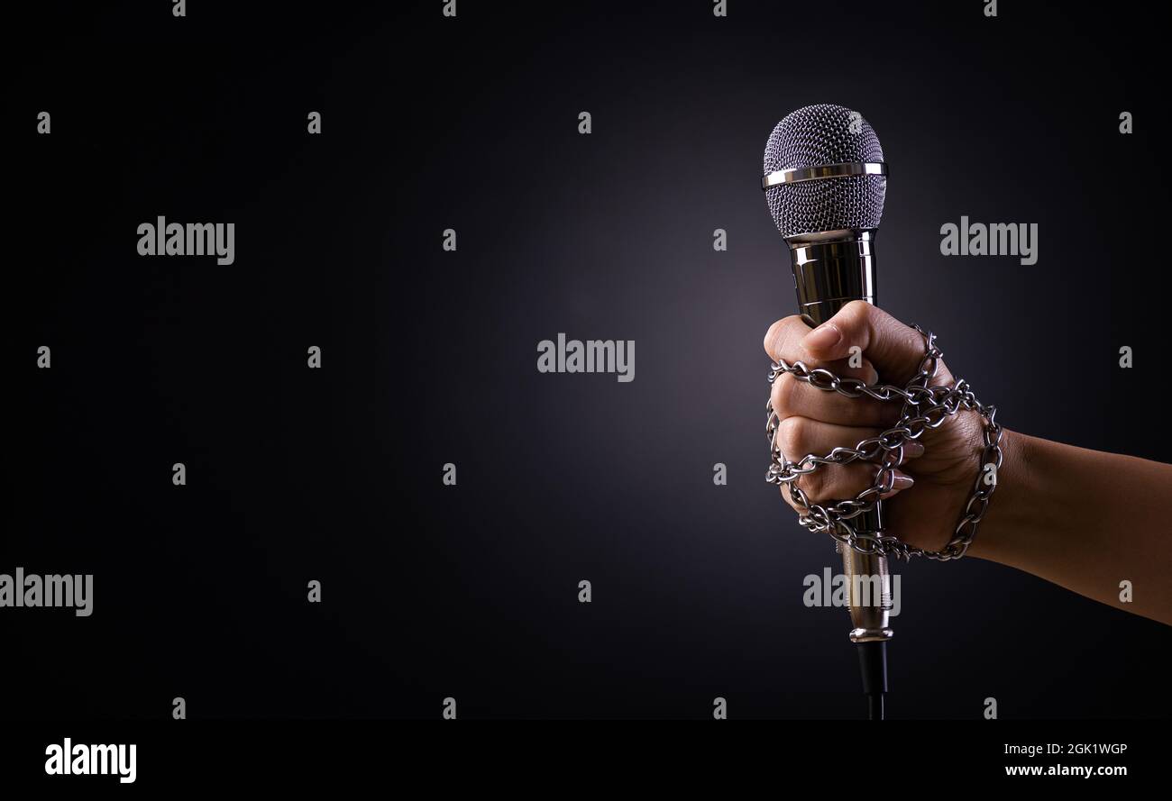 World press freedom day concept. Hand holding a microphone with chain ...