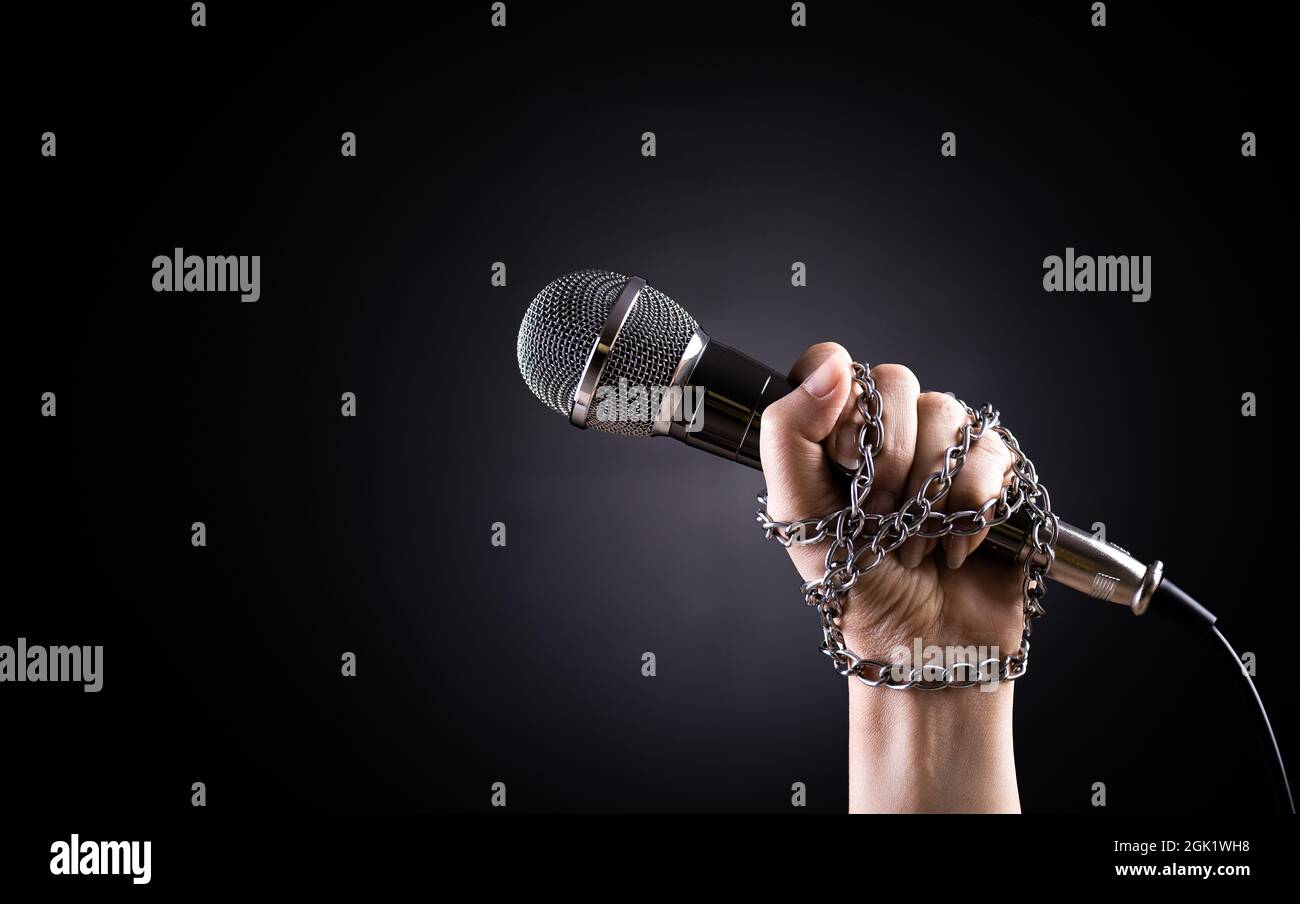 World press freedom day concept. Hand holding a microphone with chain ...