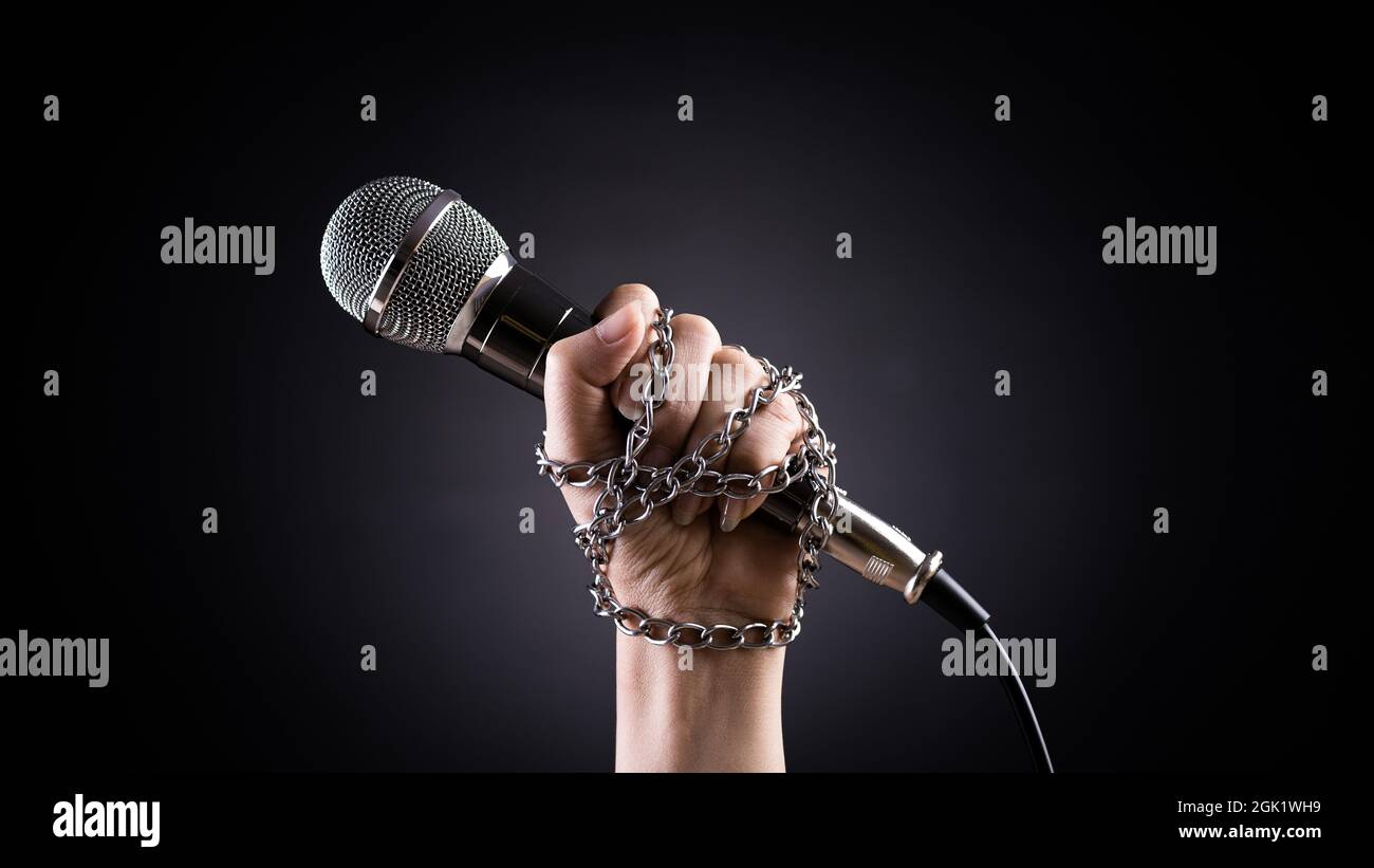 World press freedom day concept. Hand holding a microphone with chain ...