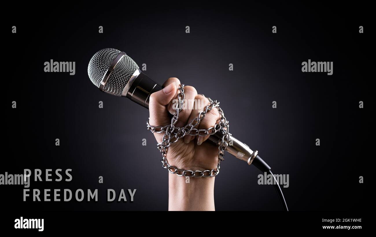 World press freedom day concept. Hand holding a microphone with chain ...