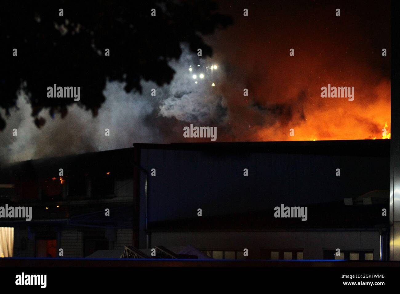 Hagen, Germany. 12th Sep, 2021. Firefighters on a turntable ladder try ...