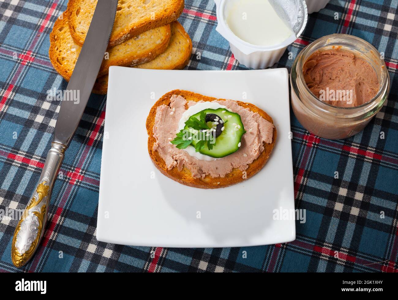 Canape with pate and young cheese and tomatoe at bread, served on desk ...
