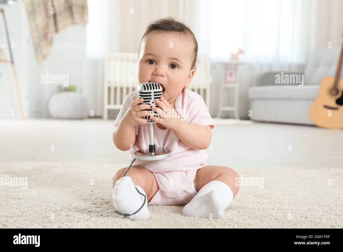 Cute little baby with microphone at home Stock Photo - Alamy