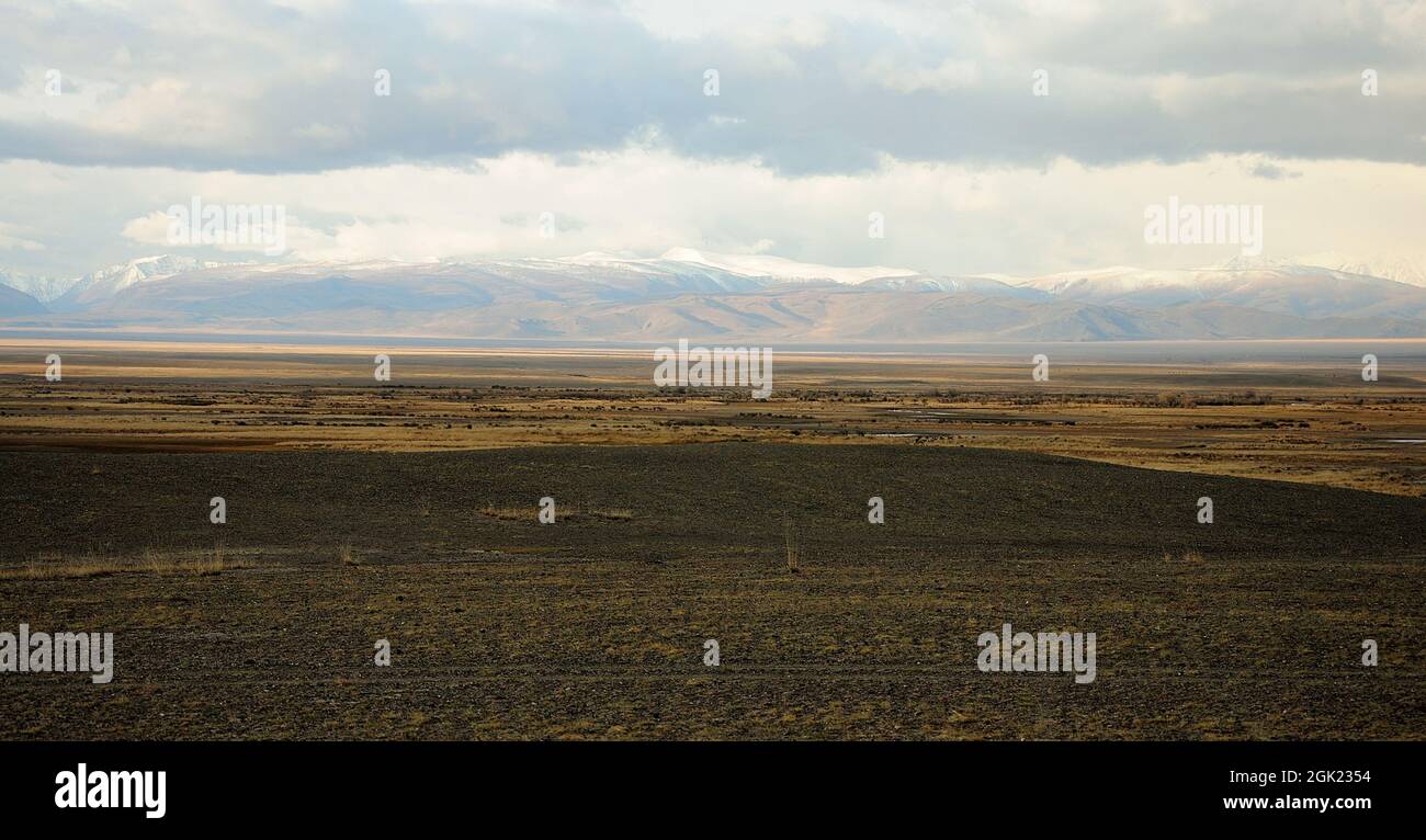 A look at the desert steppe in autumn at the foot of a high mountain ...