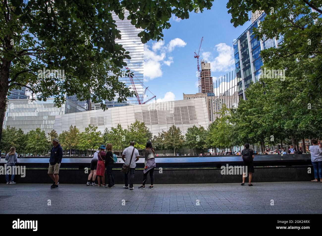 Visitors gather to pay tribute to the victims of 9/11 attacks near one ...