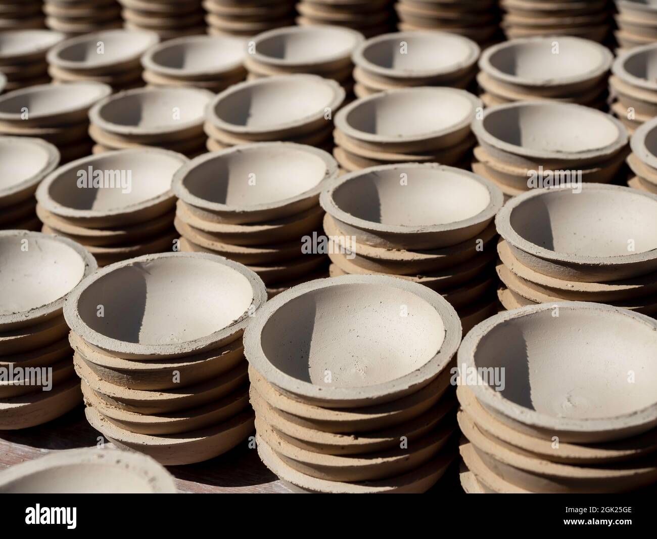 Many small plates, round shape made by ceramic clay and dried with ...