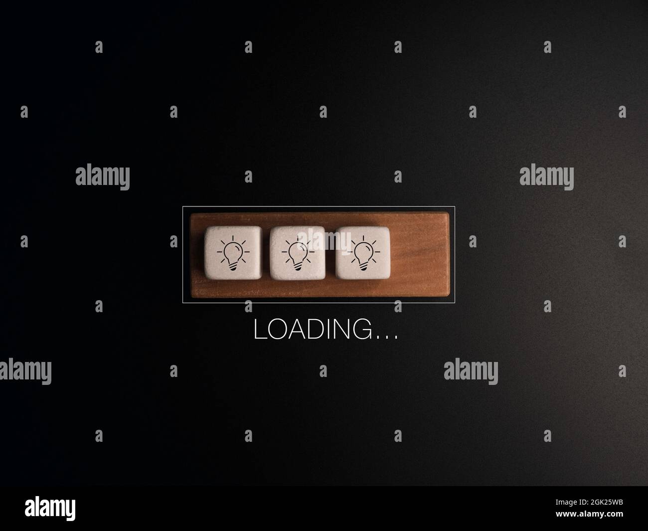 Loading..., the word with light bulb icon on white dices and wood cube ...