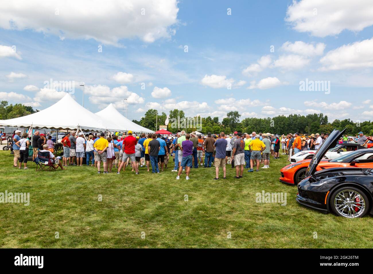 A crowd gathers around the tents at a car show in Fort Wayne, Indiana ...