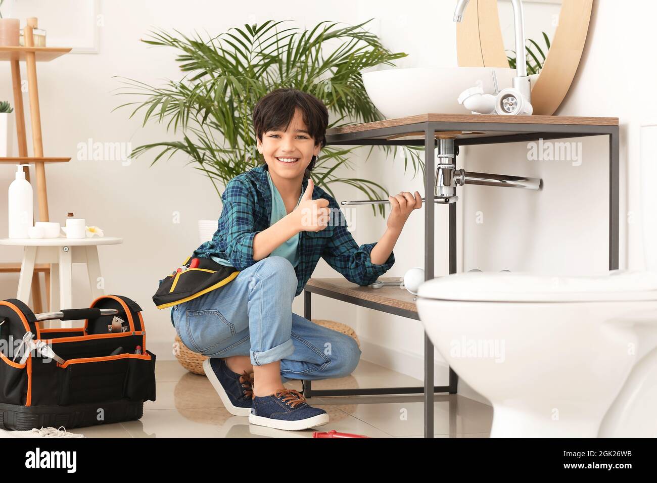 Portrait of little plumber in restroom Stock Photo - Alamy