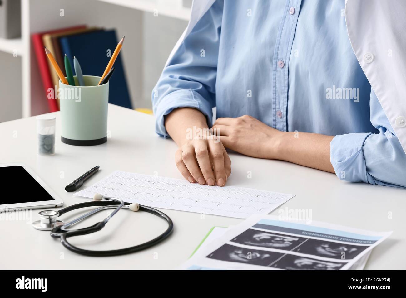 Female doctor writing prescription in clinic Stock Photo - Alamy