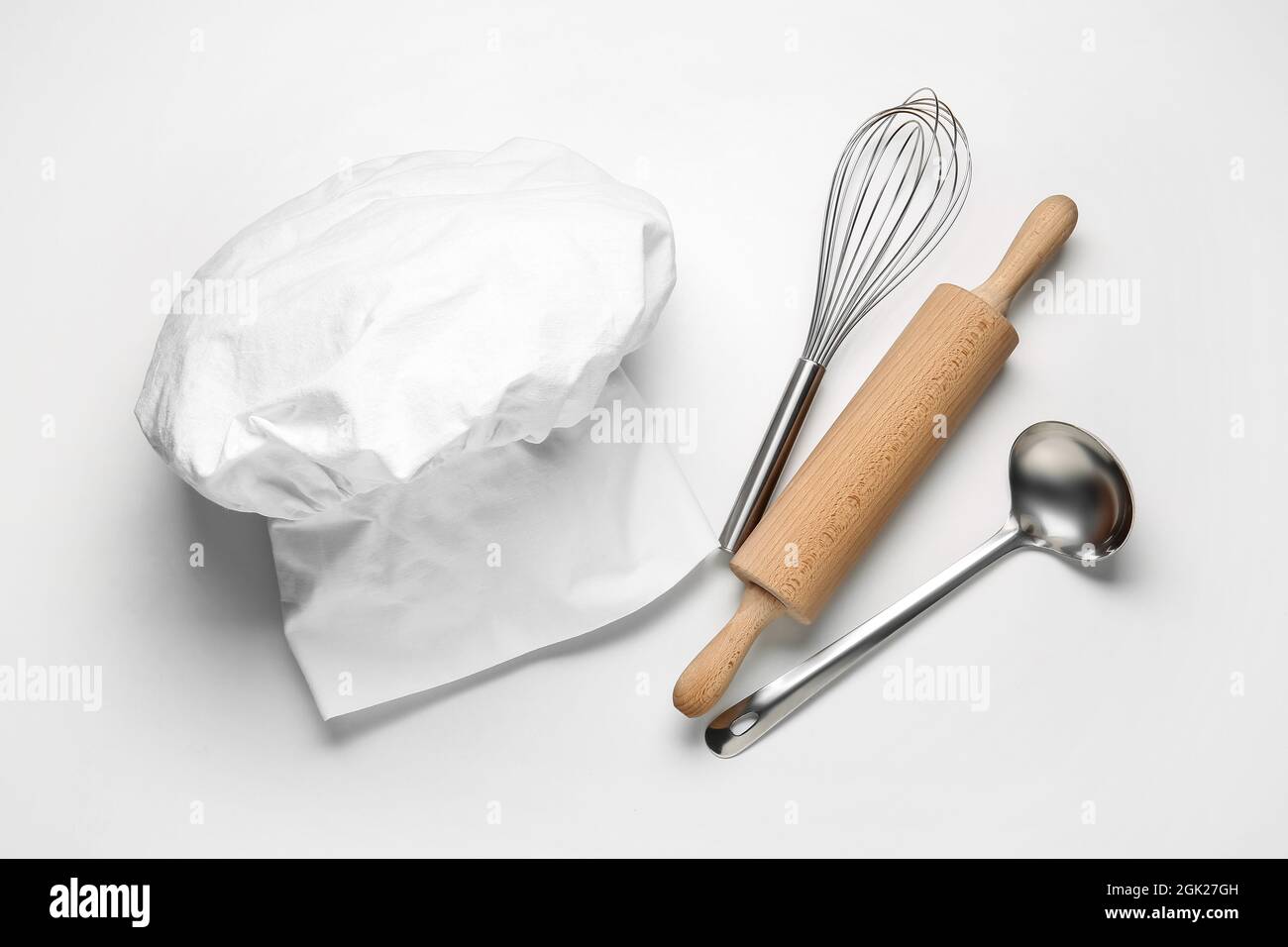 Chef's hat and kitchen utensils on white background Stock Photo - Alamy