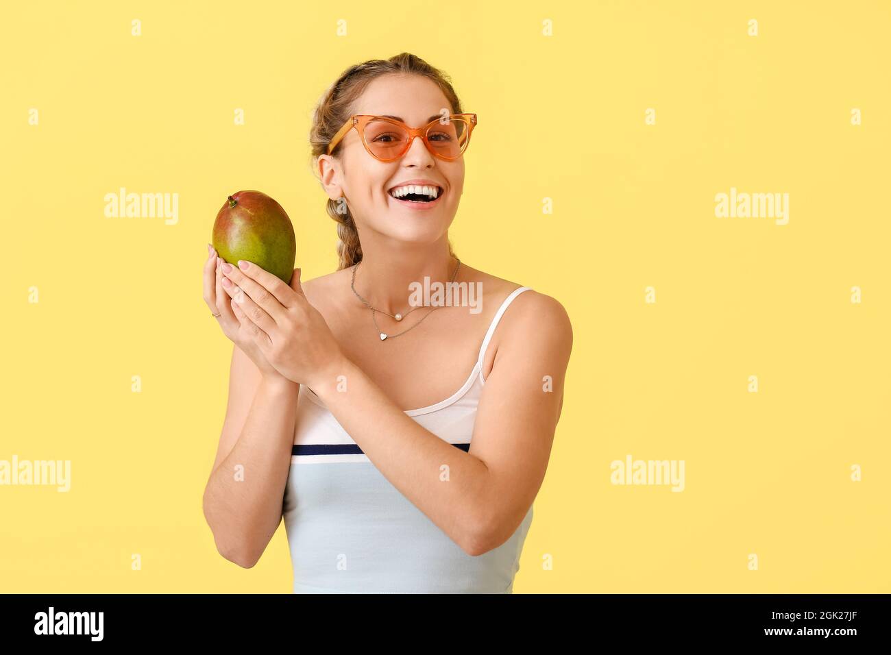 Young woman eating mango model hi-res stock photography and images - Alamy