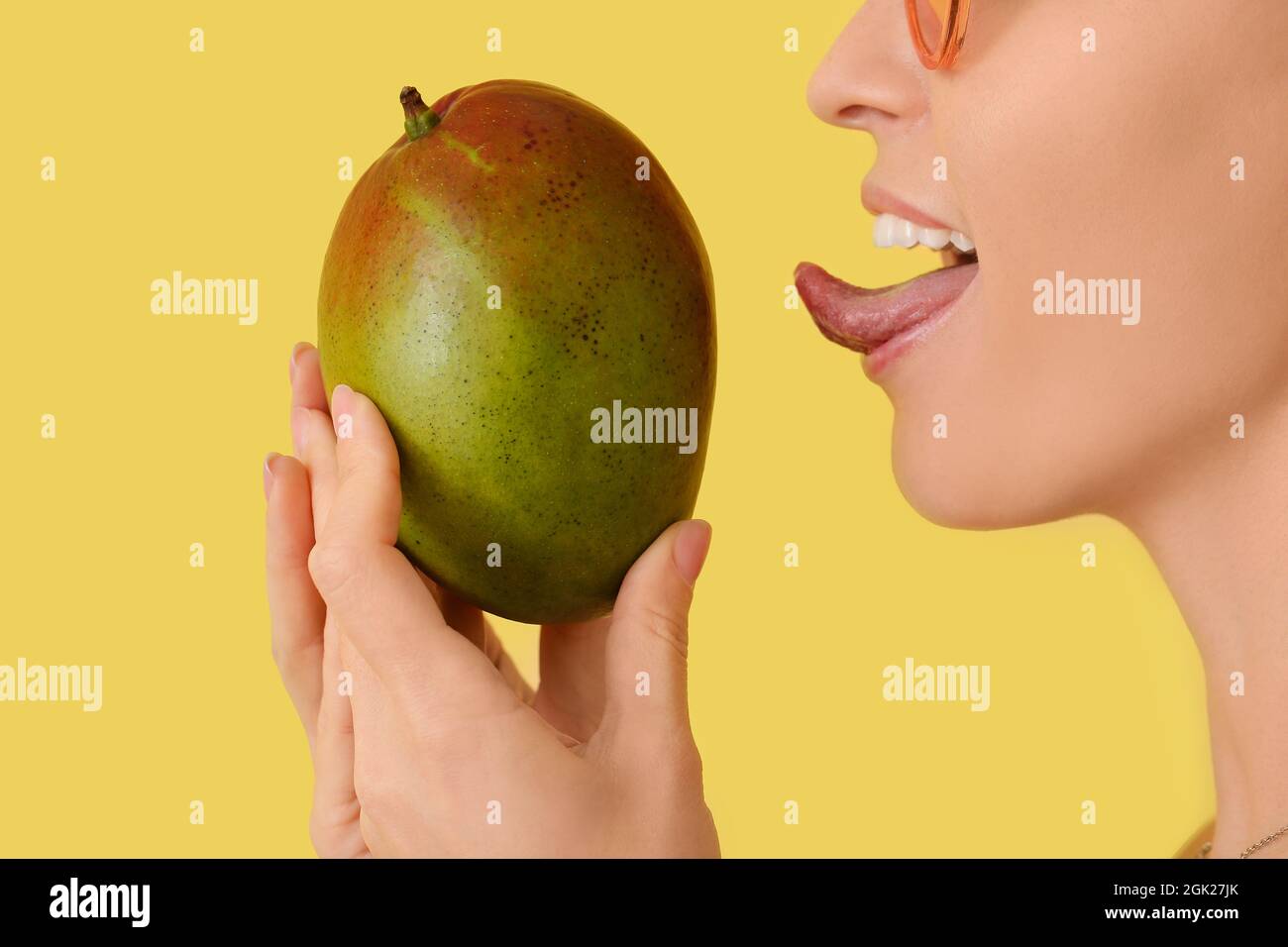 Young woman eating mango model hi-res stock photography and images - Alamy