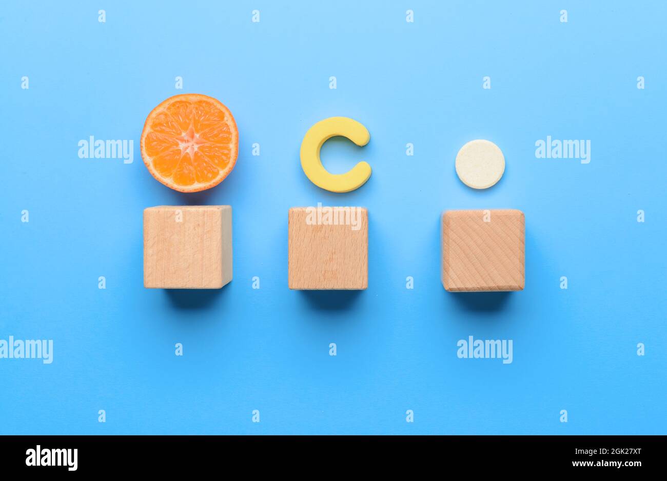 Cut orange, letter C and pill on color background Stock Photo - Alamy