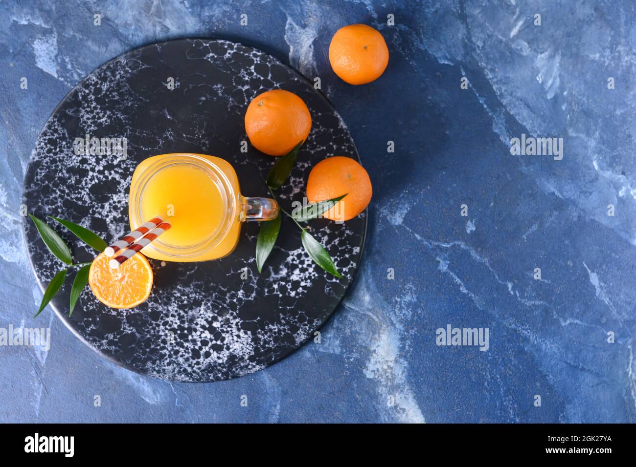 Mason jar with tasty mandarin juice on color background Stock Photo - Alamy