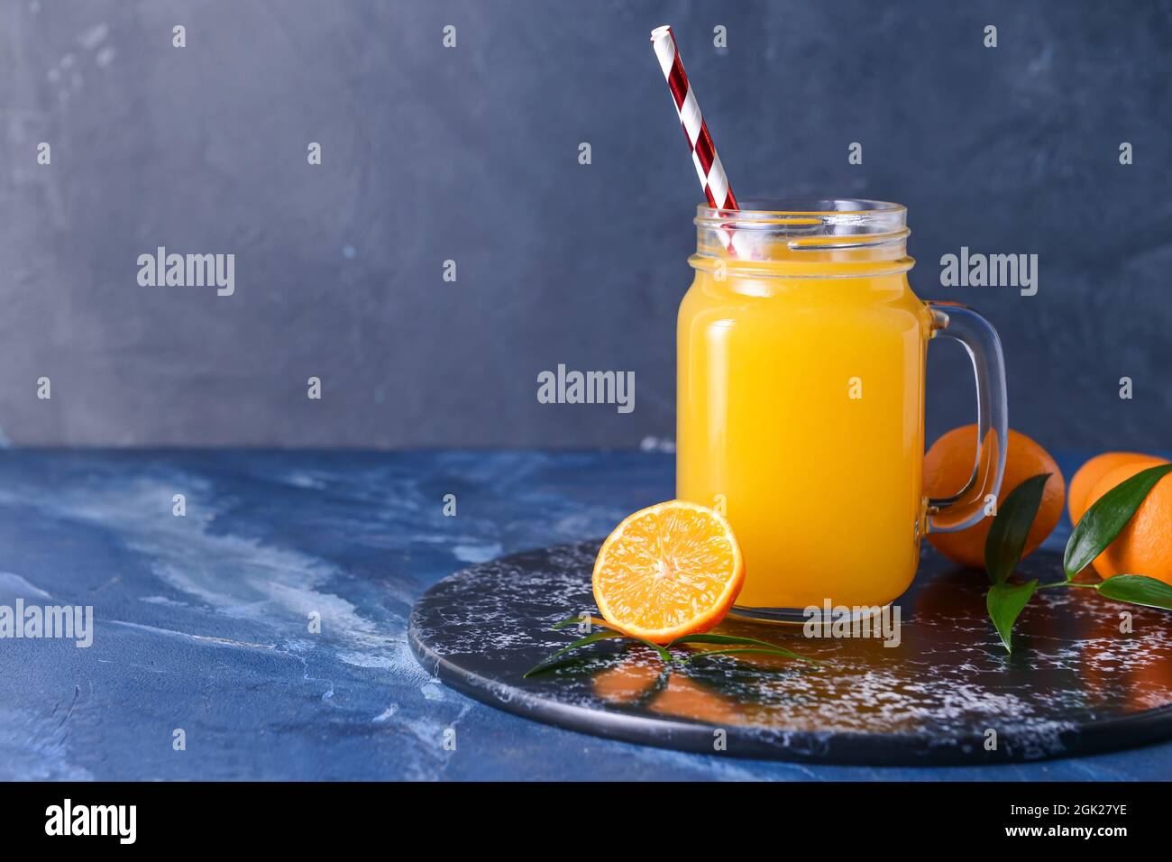 Mason jar with tasty mandarin juice on color background Stock Photo - Alamy