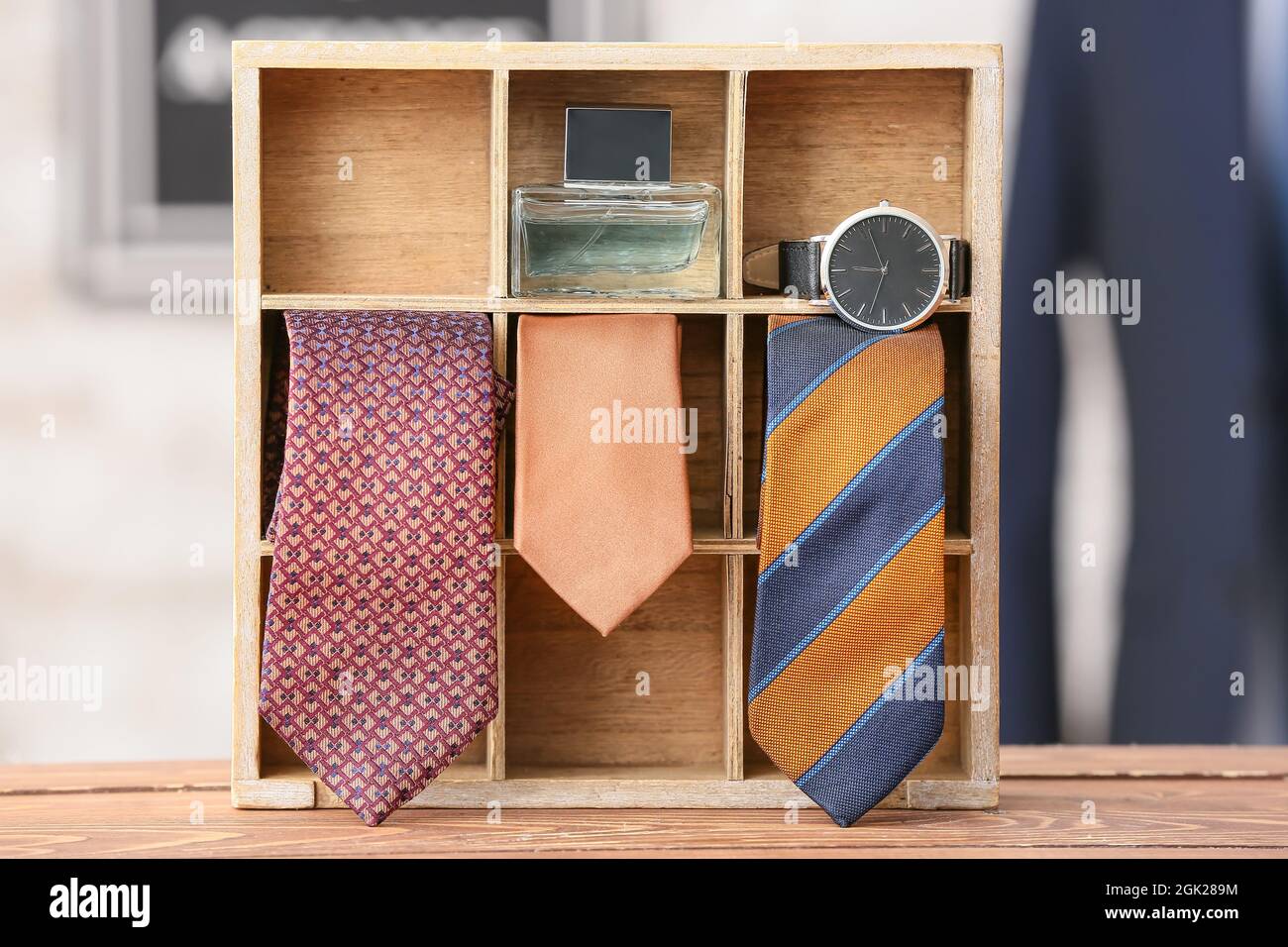 Box with neckties, perfume and wristwatch on table, closeup Stock Photo ...