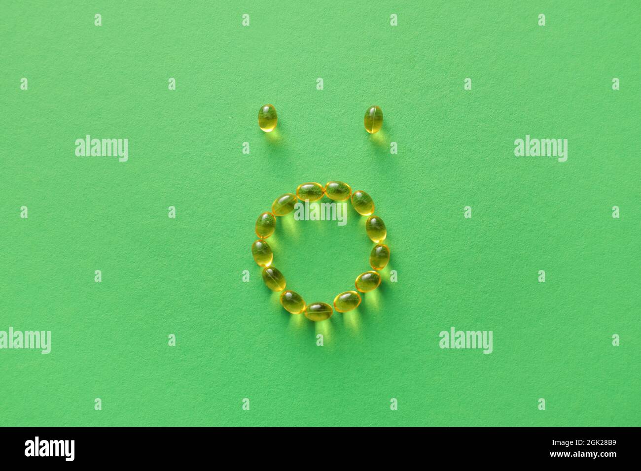 Surprised face made of pills on color background Stock Photo - Alamy