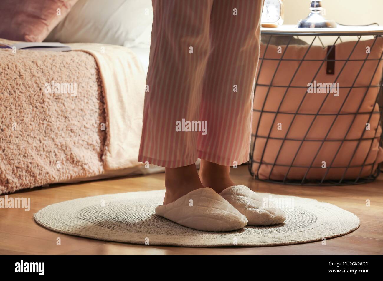 Woman wearing soft slippers in bedroom, closeup Stock Photo - Alamy