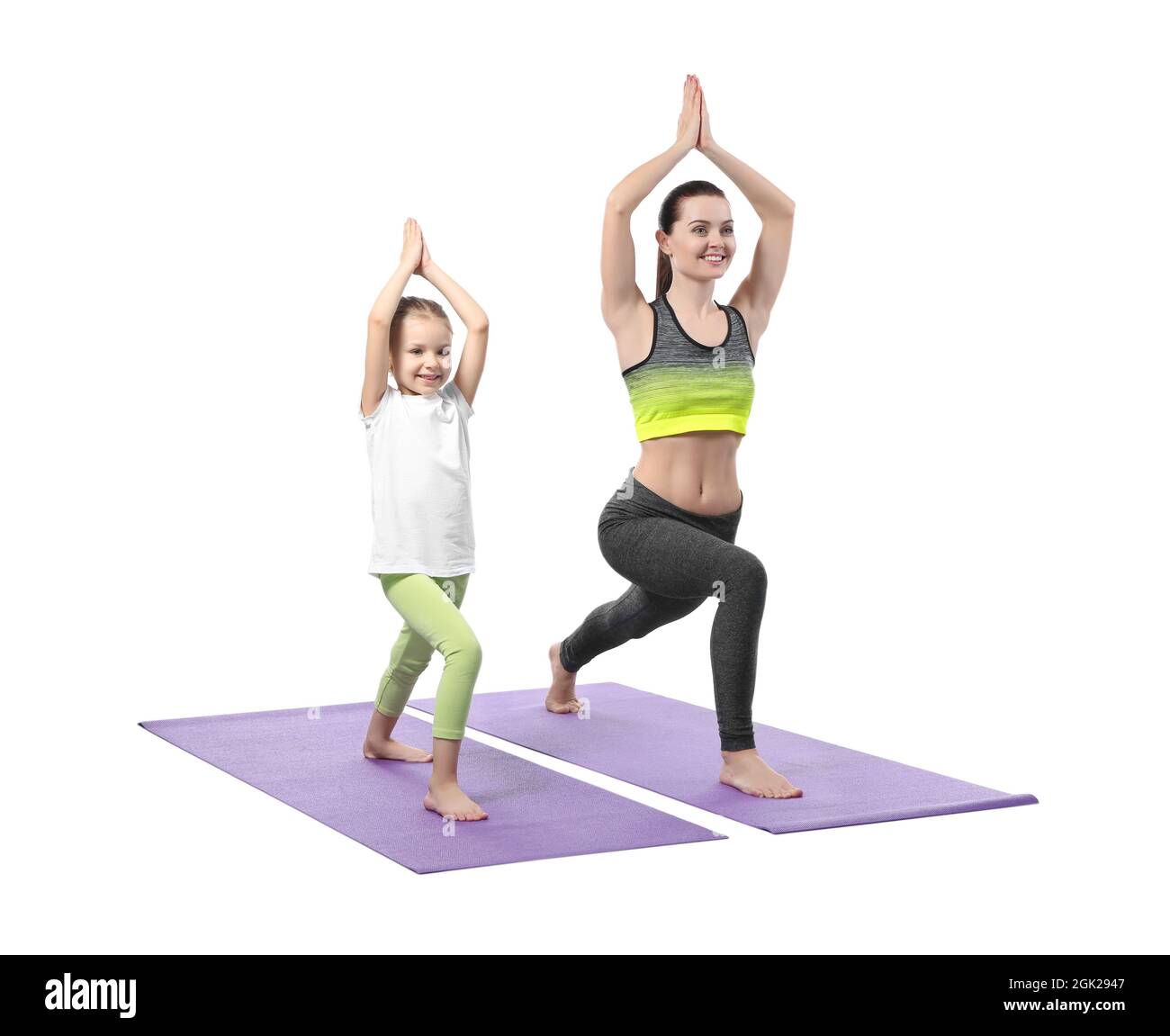Mother and daughter doing exercise on white background Stock Photo - Alamy