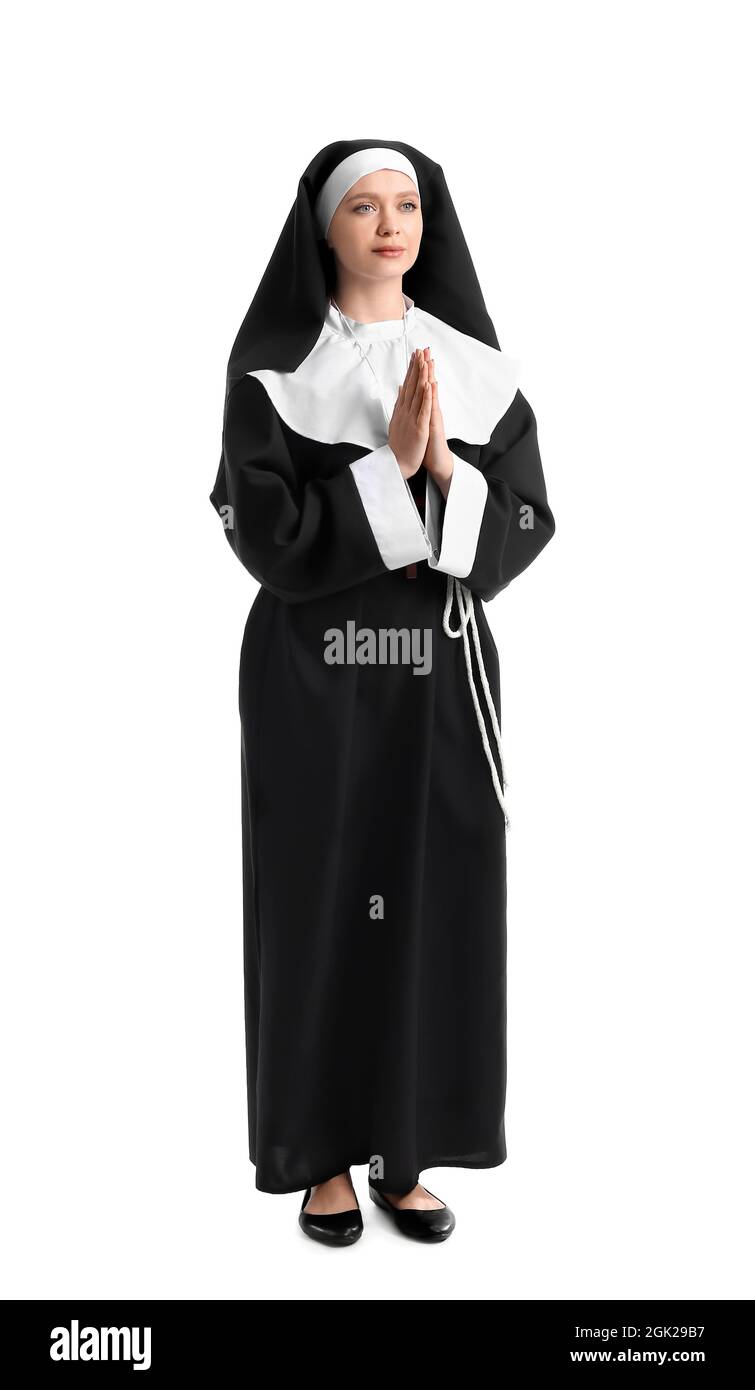 Young praying nun on white background Stock Photo - Alamy