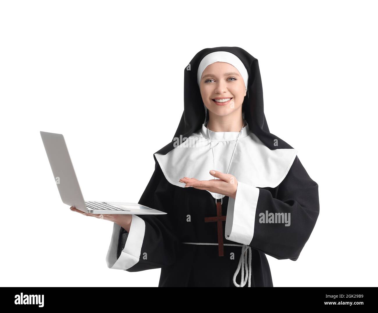 Young nun with laptop on white background Stock Photo - Alamy