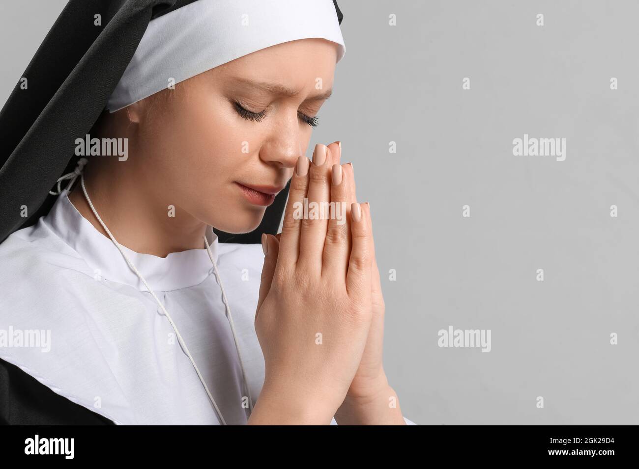 Young nun praying hi-res stock photography and images - Alamy