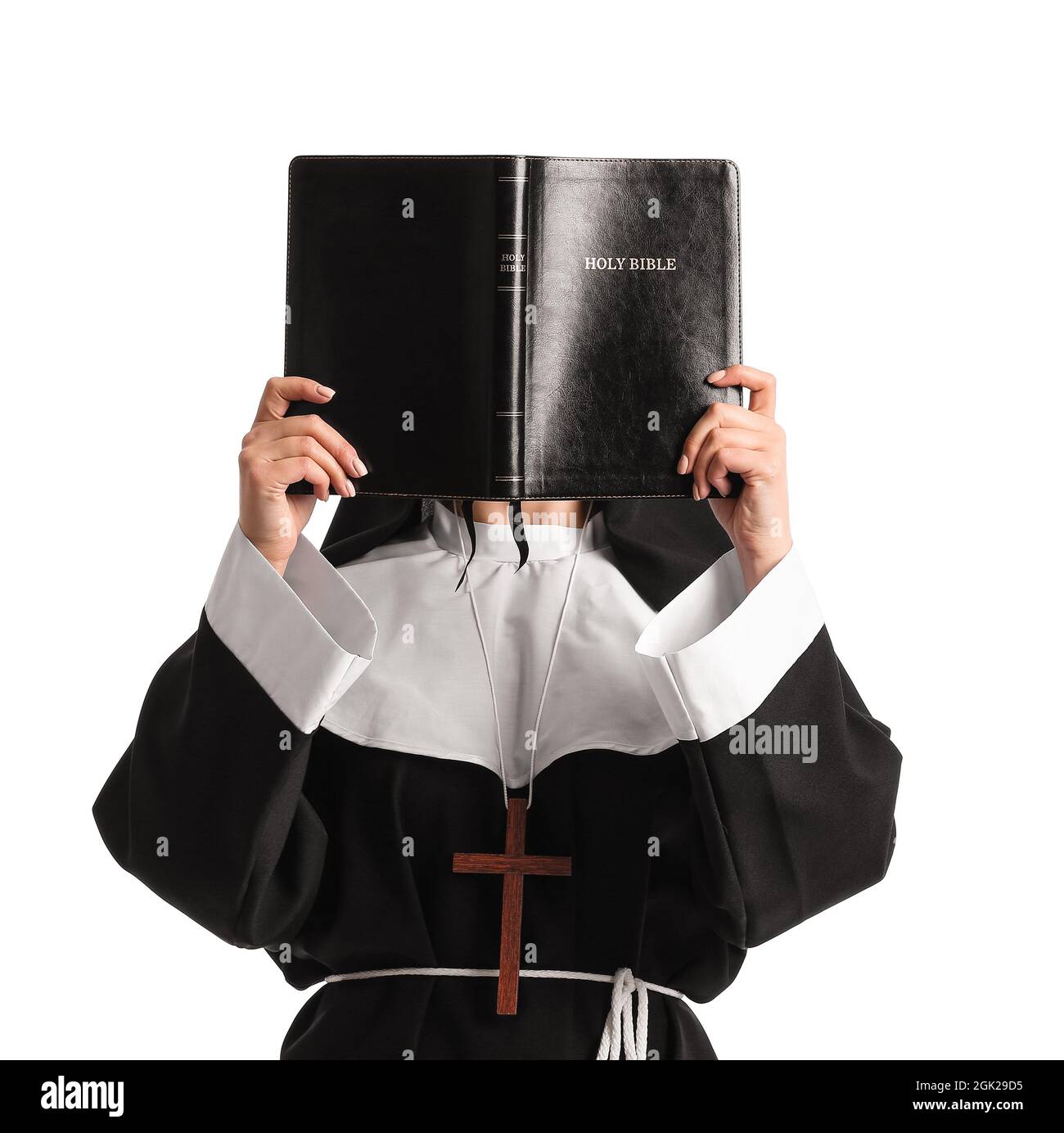Young nun with Bible on white background Stock Photo - Alamy