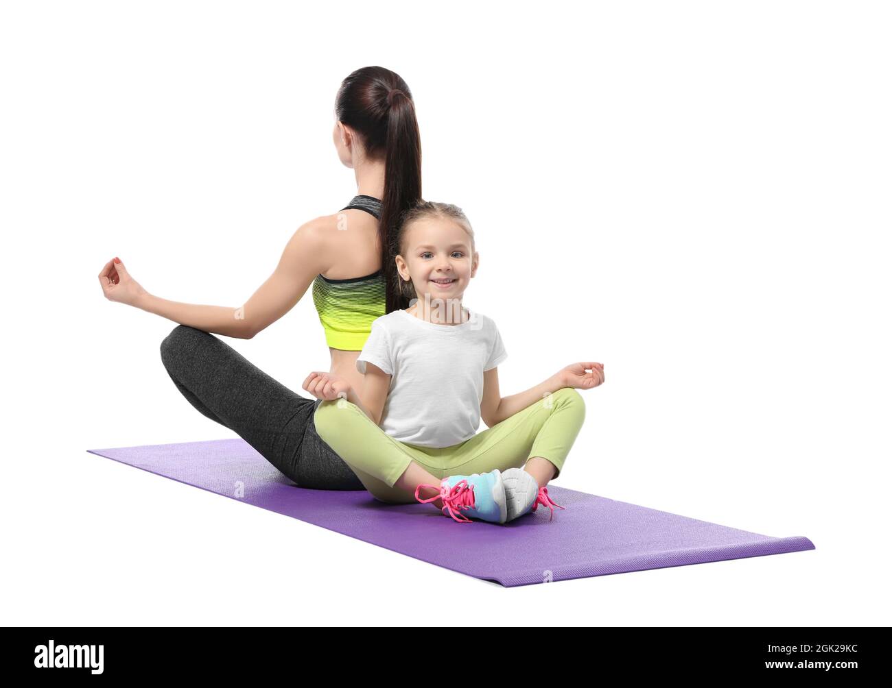 Mother and daughter doing exercise on white background Stock Photo - Alamy