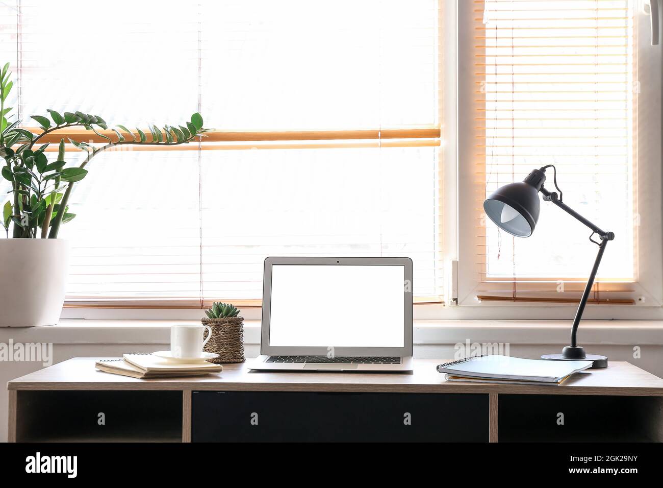 Modern workplace with laptop near window Stock Photo - Alamy