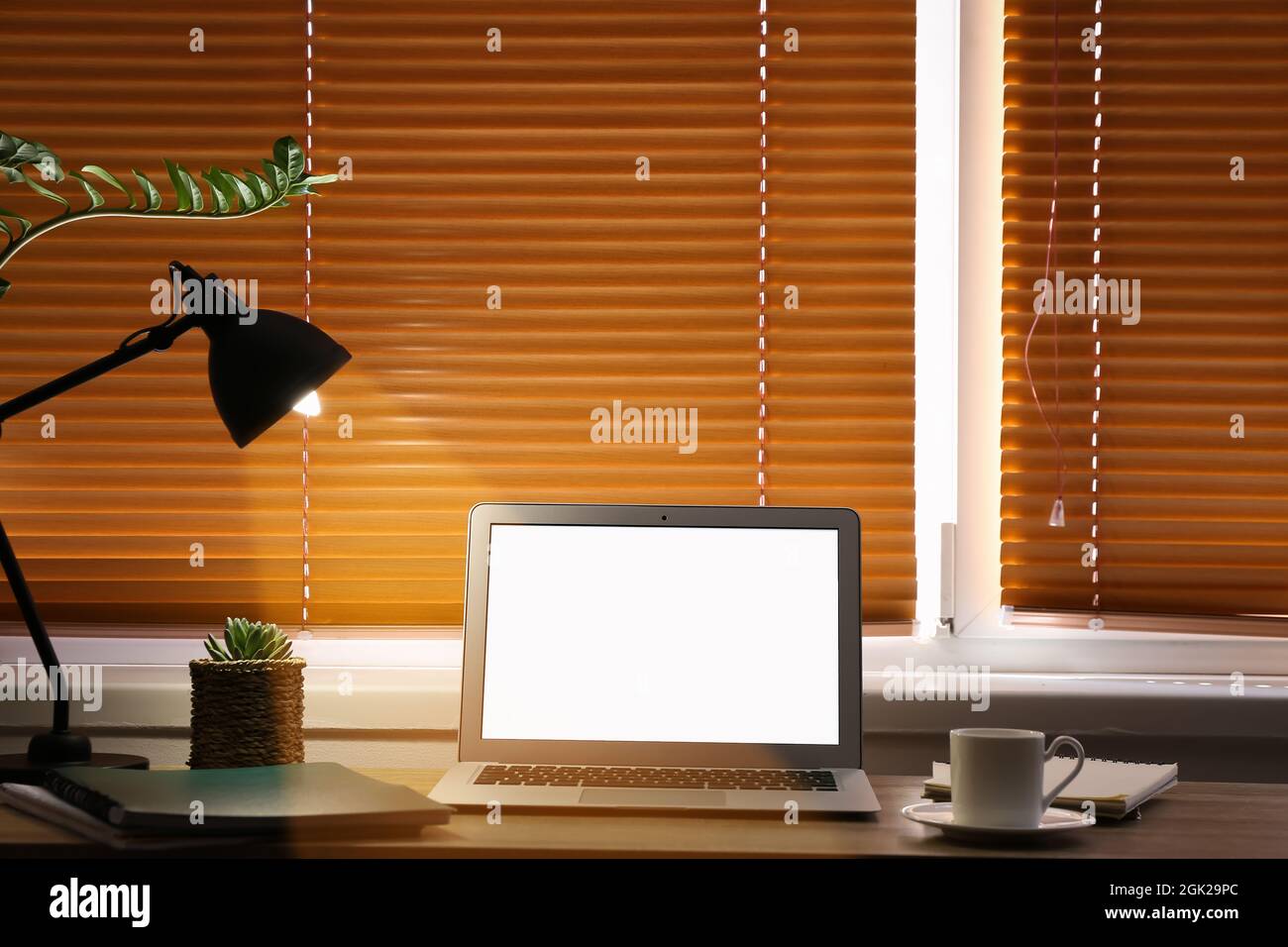 Modern workplace with laptop near window Stock Photo - Alamy