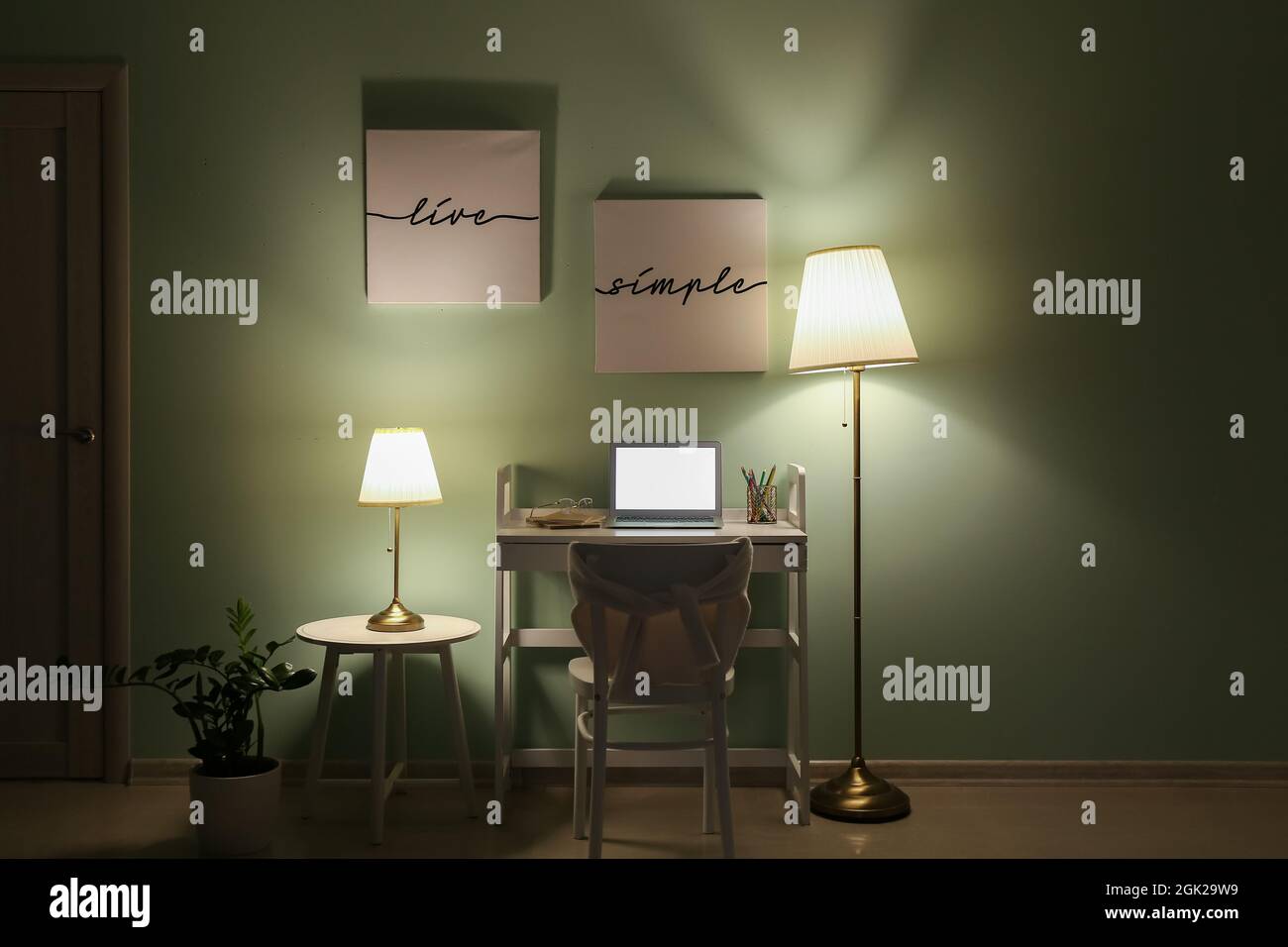 Interior of dark room with modern workplace and glowing lamps Stock ...