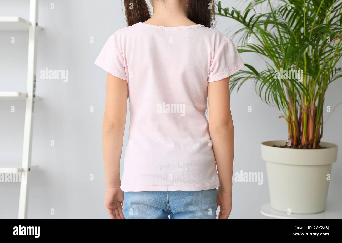 Little girl in stylish t-shirt at home, back view Stock Photo - Alamy