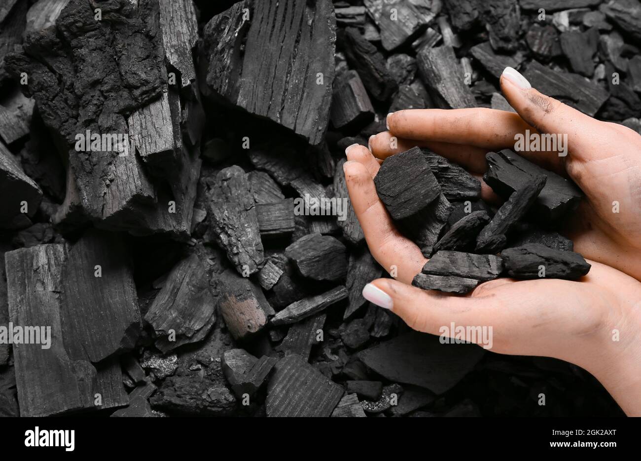 Female hands with char coal as background Stock Photo - Alamy