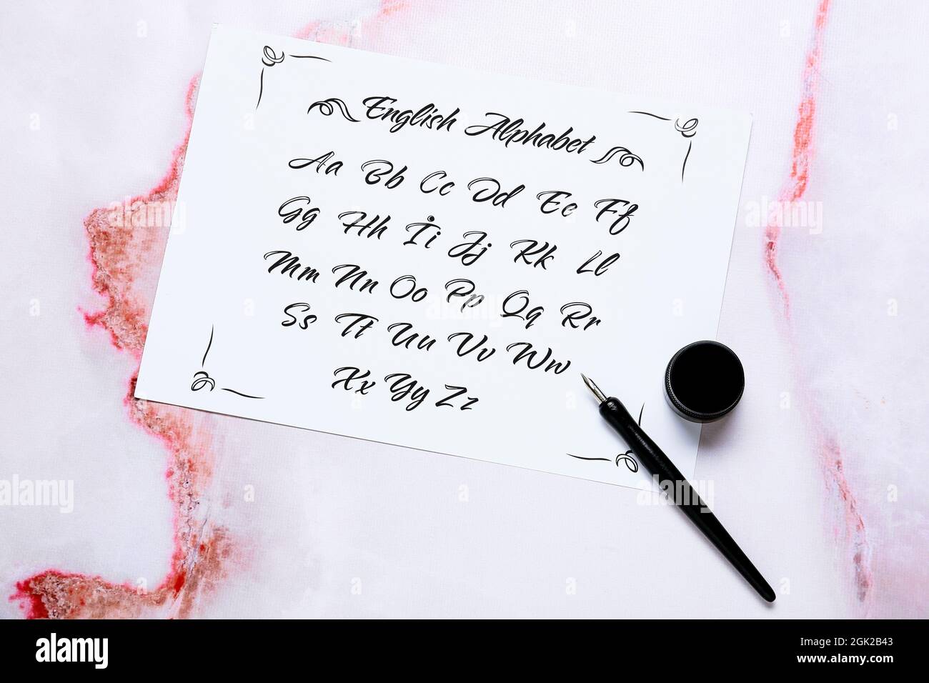 Paper with English alphabet, nib pen and ink on light background Stock ...