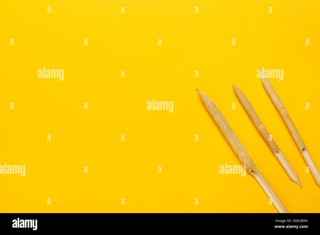 Wooden dip pens on yellow background Stock Photo - Alamy