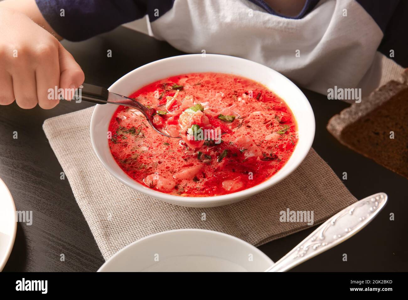 Boy eating with soup spoon hi-res stock photography and images - Alamy
