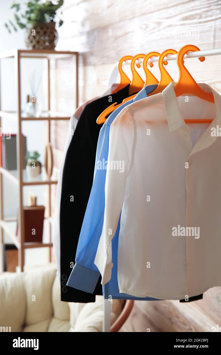 Rack with stylish school uniform in room Stock Photo - Alamy
