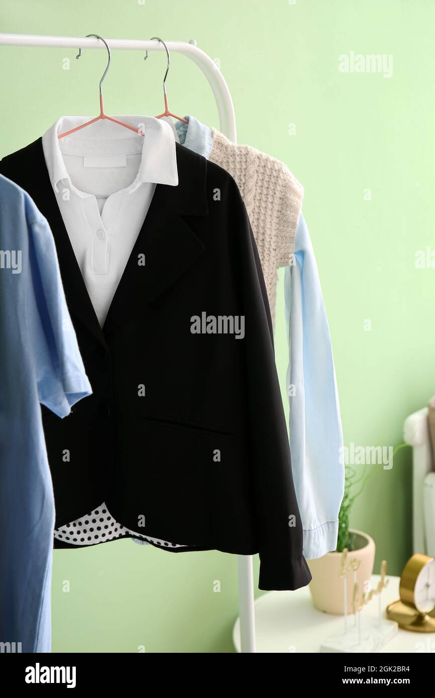 Rack with stylish school uniform in room Stock Photo - Alamy