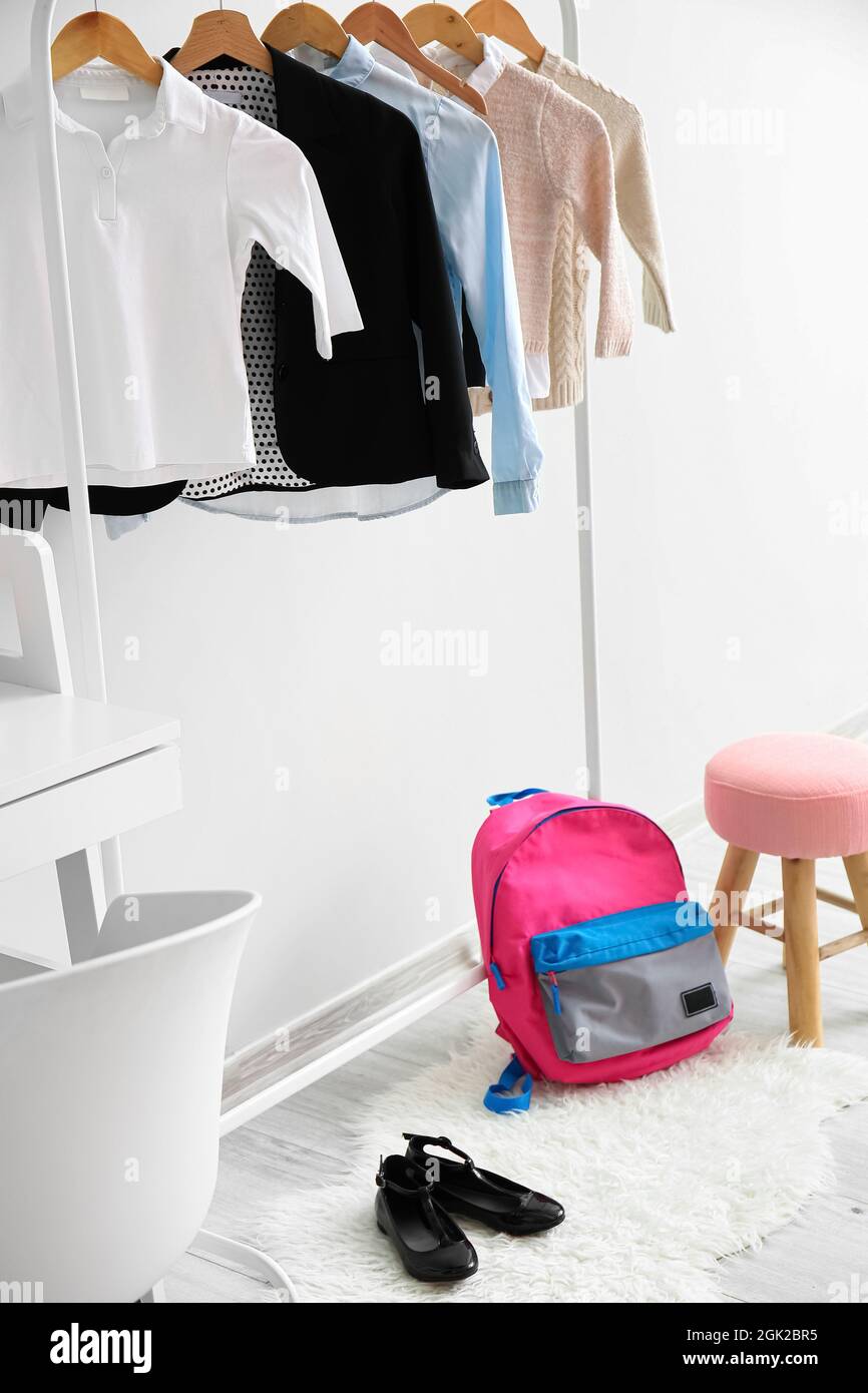 Rack with school uniform in interior of room Stock Photo - Alamy