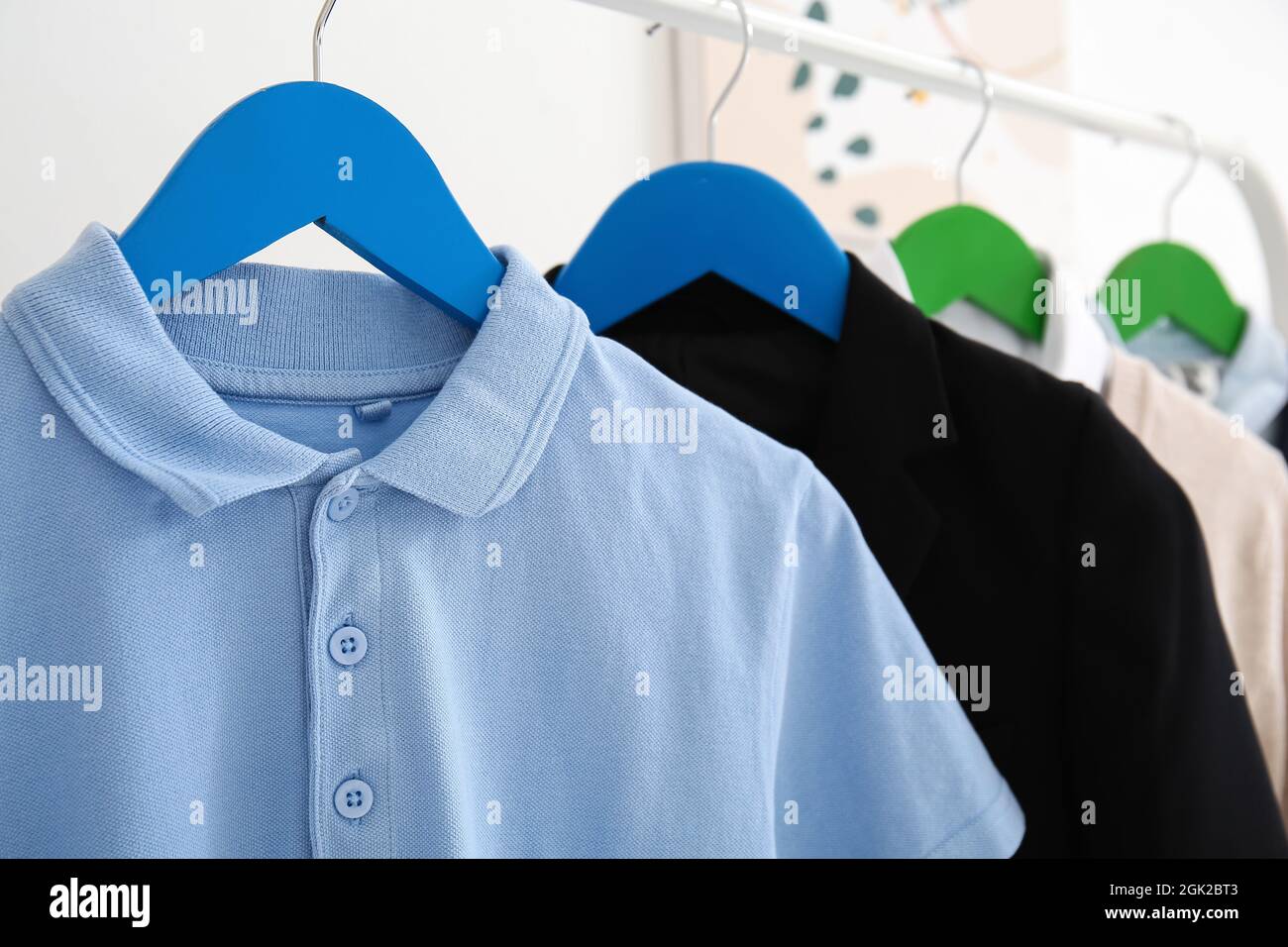 Rack with stylish school uniform in room Stock Photo - Alamy