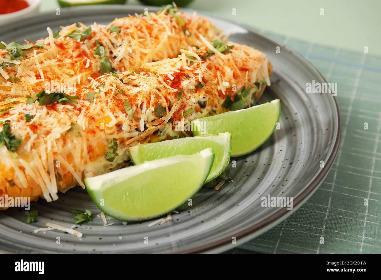 Plate with tasty Elote Mexican Street Corn on table, closeup Stock ...